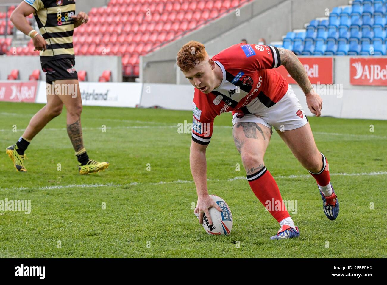 Harvey Livett (20) of Salford Red Devils goes over for a try to make it ...