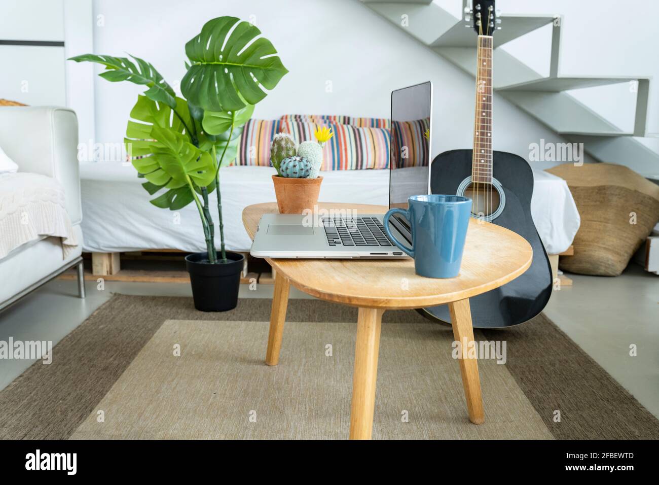 Laptop on coffee table in living room Stock Photo - Alamy