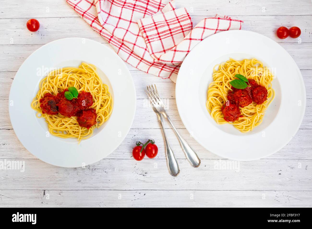 Two plates of spaghetti with vegetarian mince balls Stock Photo - Alamy