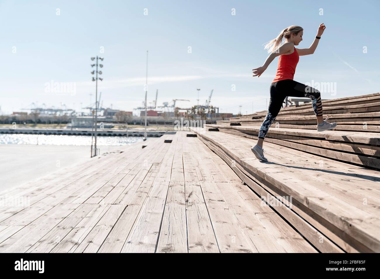 Young woman running on steps Stock Photo - Alamy