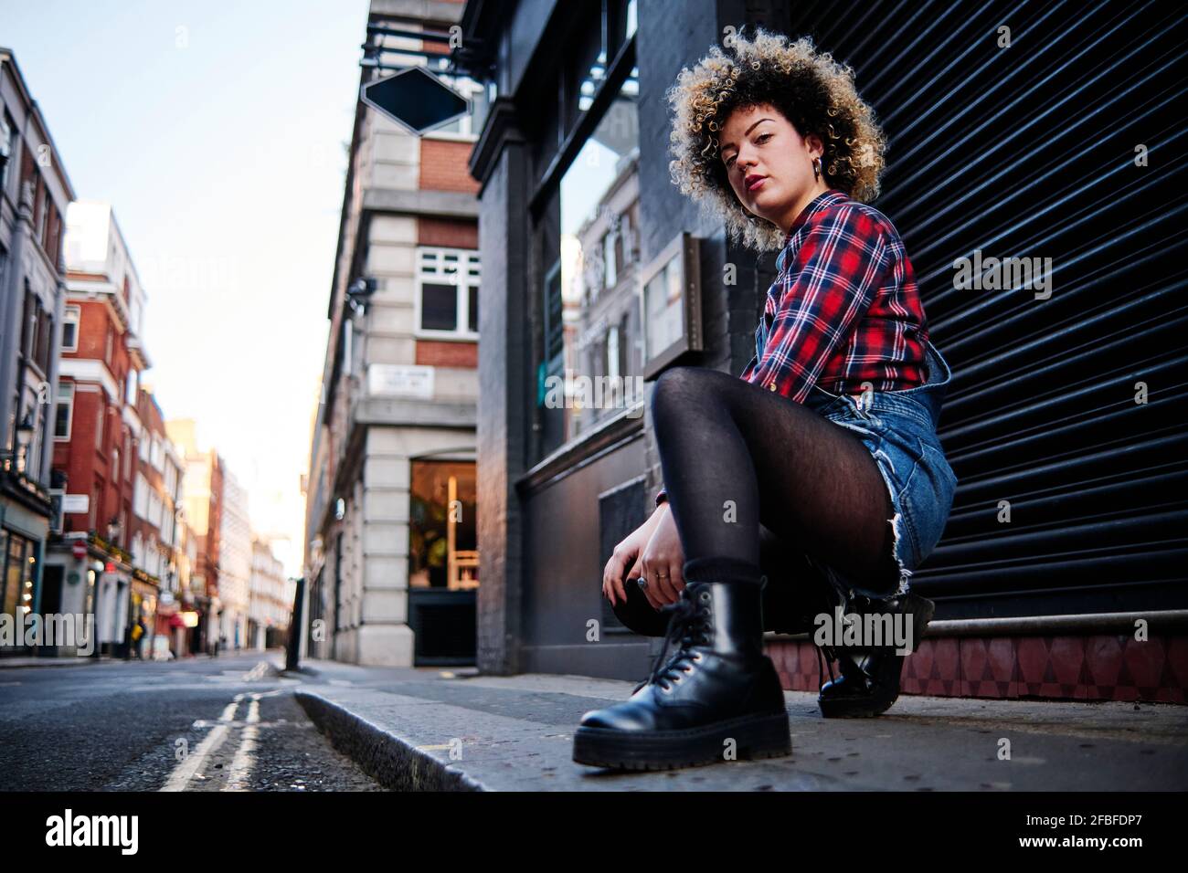 Portrait young woman crouching on hi-res stock photography and images ...