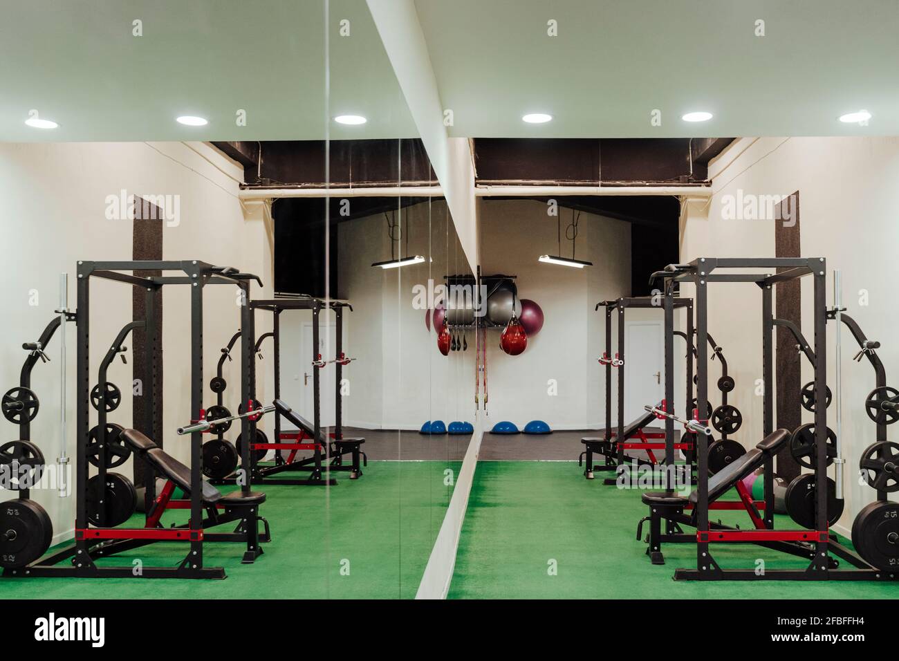 Exercise machine by mirror in health club Stock Photo - Alamy
