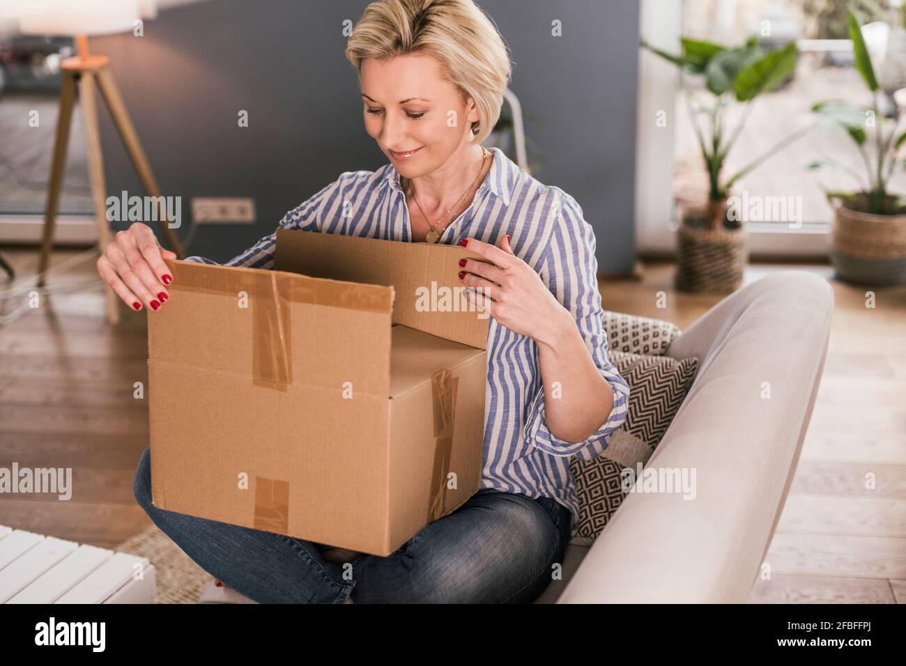 Mature woman opening package hi-res stock photography and images - Alamy