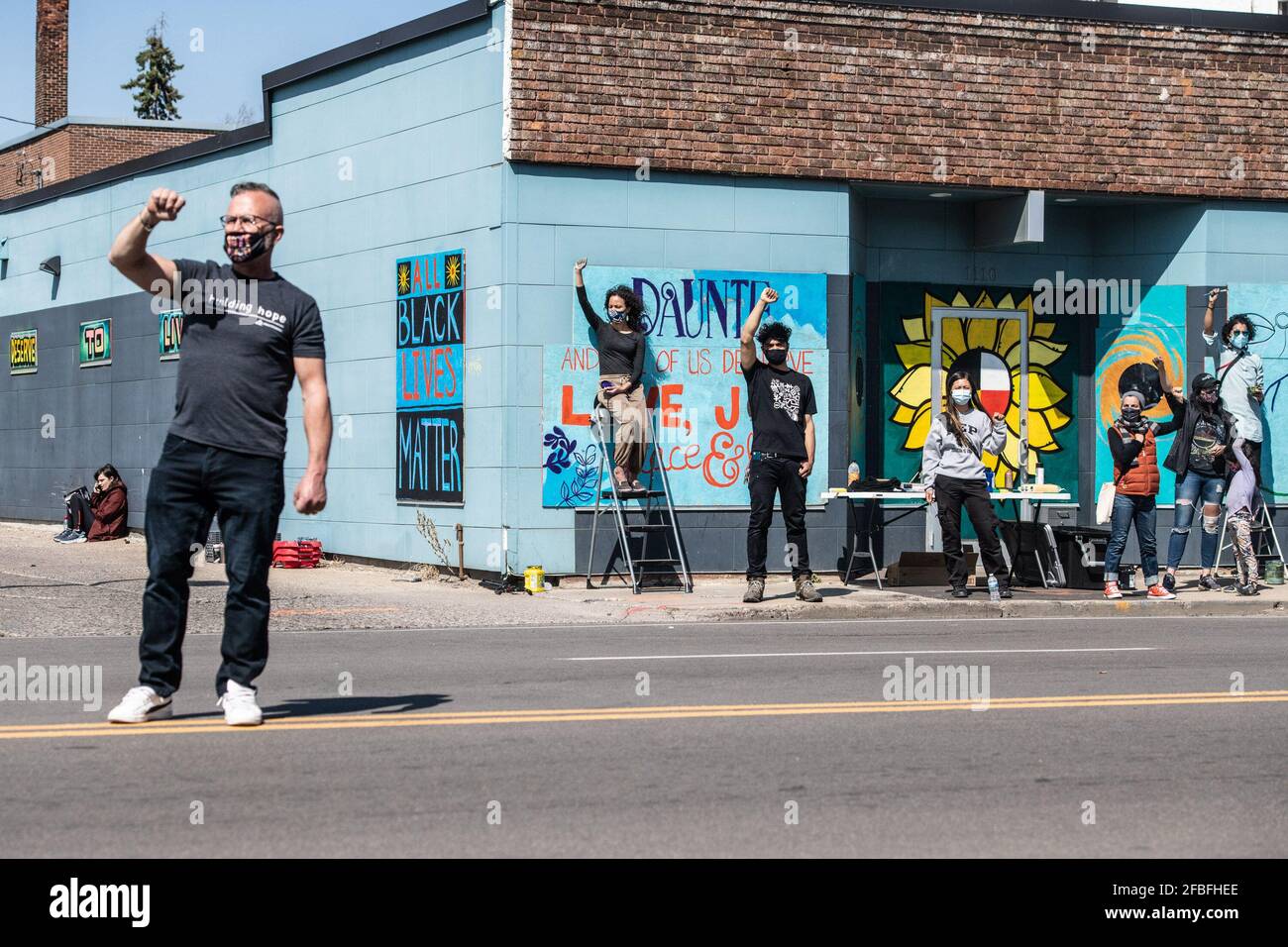 People hold up their fists in solidarity during Daunte Wright's funeral ...