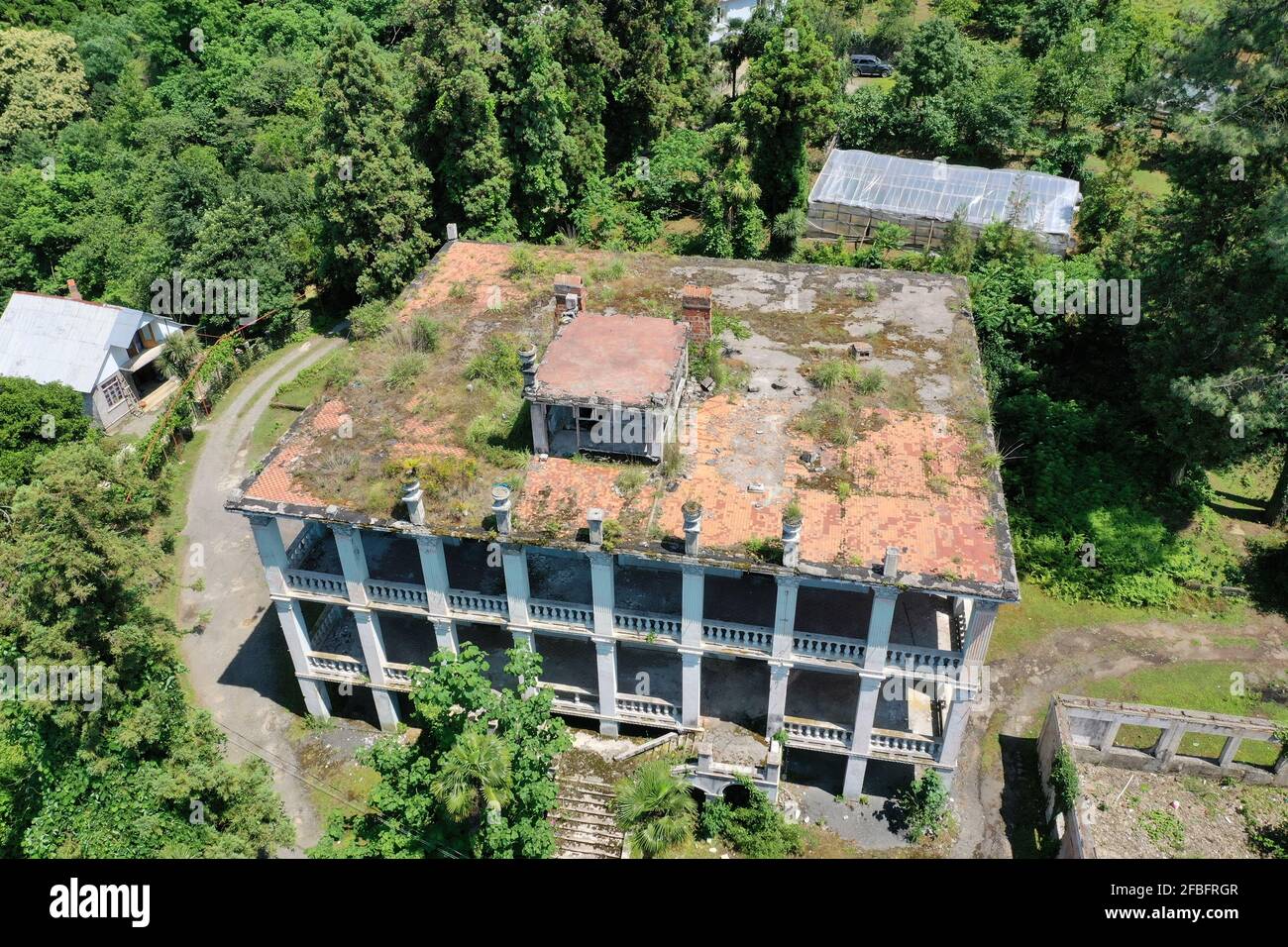 a ruined manor house with a red roof view from a drone Stock Photo - Alamy