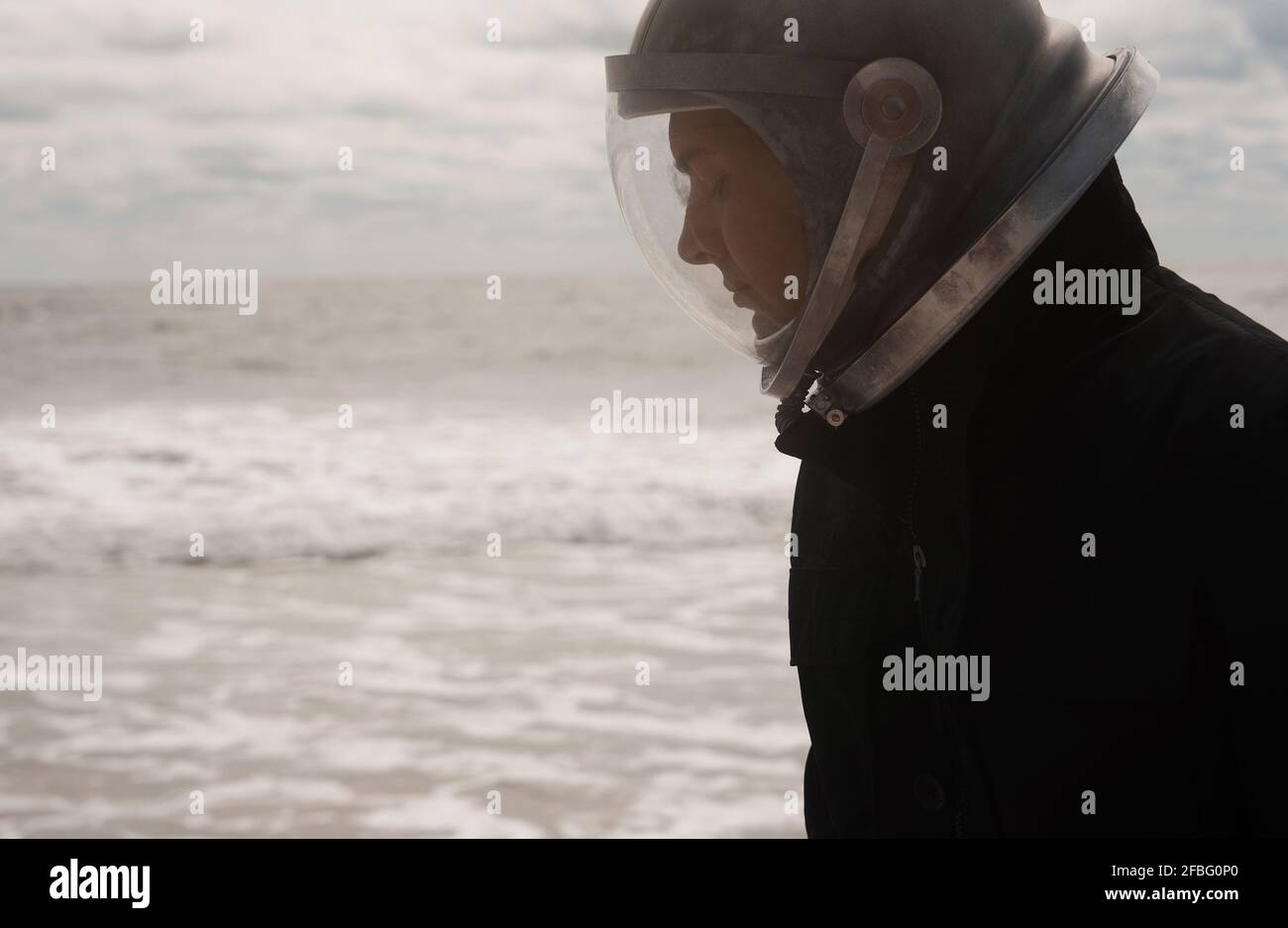 Astronautic man in space helmet at beach Stock Photo - Alamy