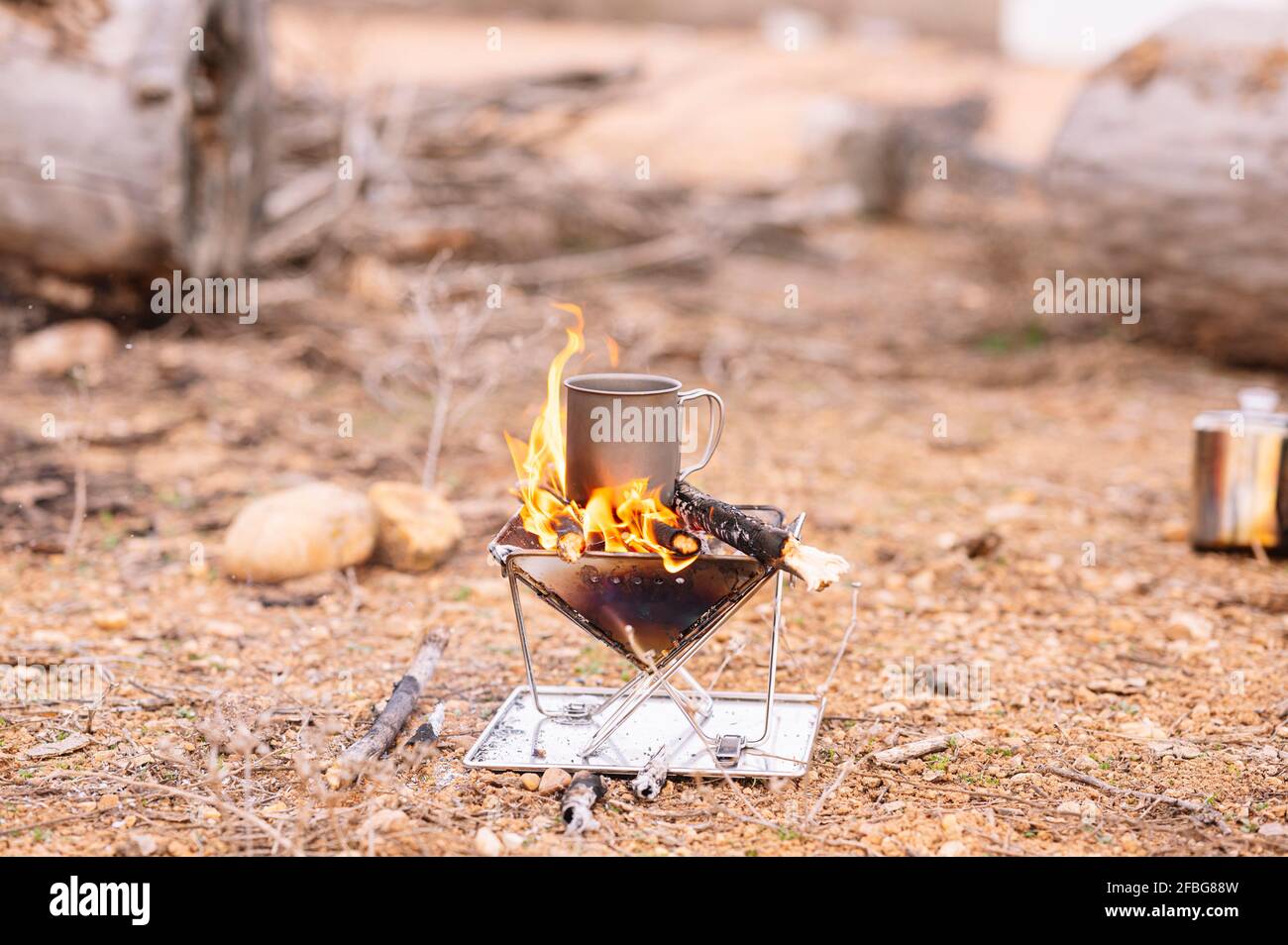 Mug on wood burning stove at ground Stock Photo - Alamy