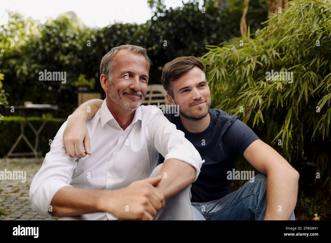 Father son sitting together in hi-res stock photography and images - Alamy