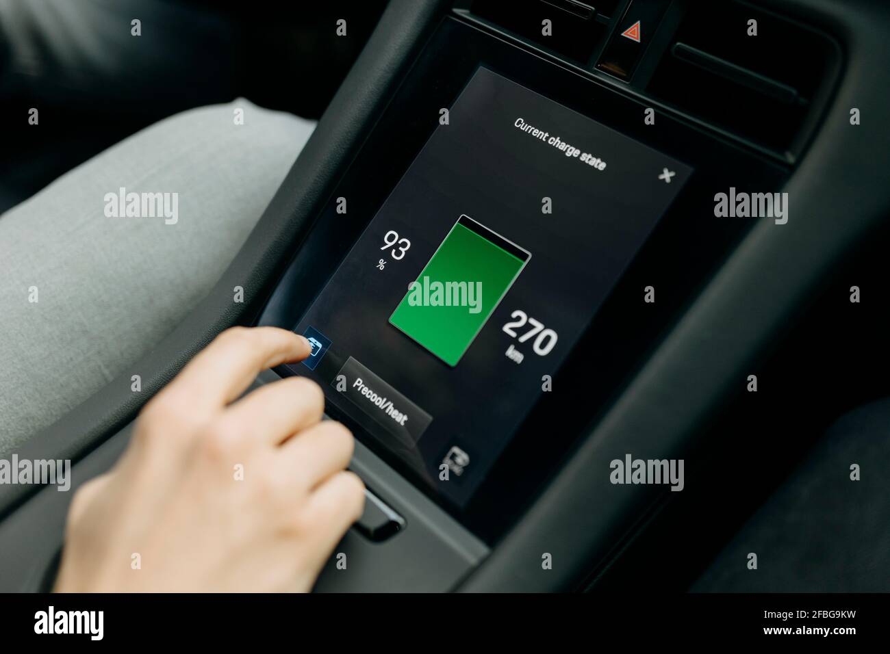 Man checking battery on screen while traveling in electric car Stock ...