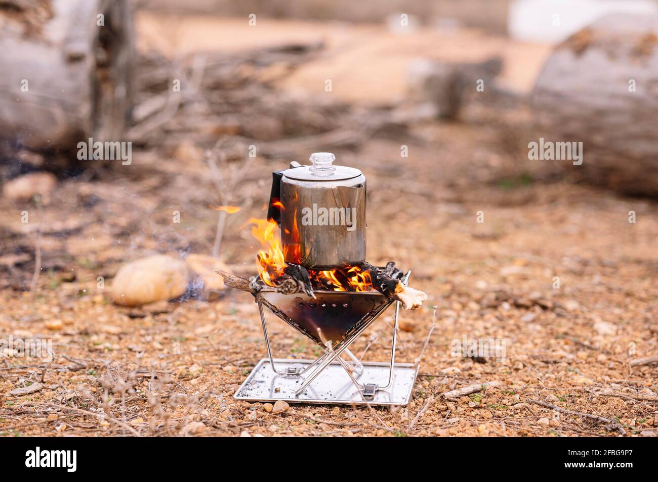 Kettle on camping stove at ground Stock Photo - Alamy