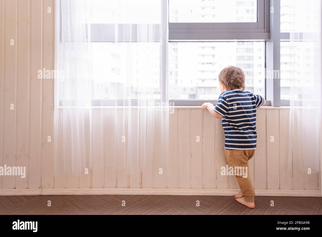 Childhood boy home window hi-res stock photography and images - Alamy