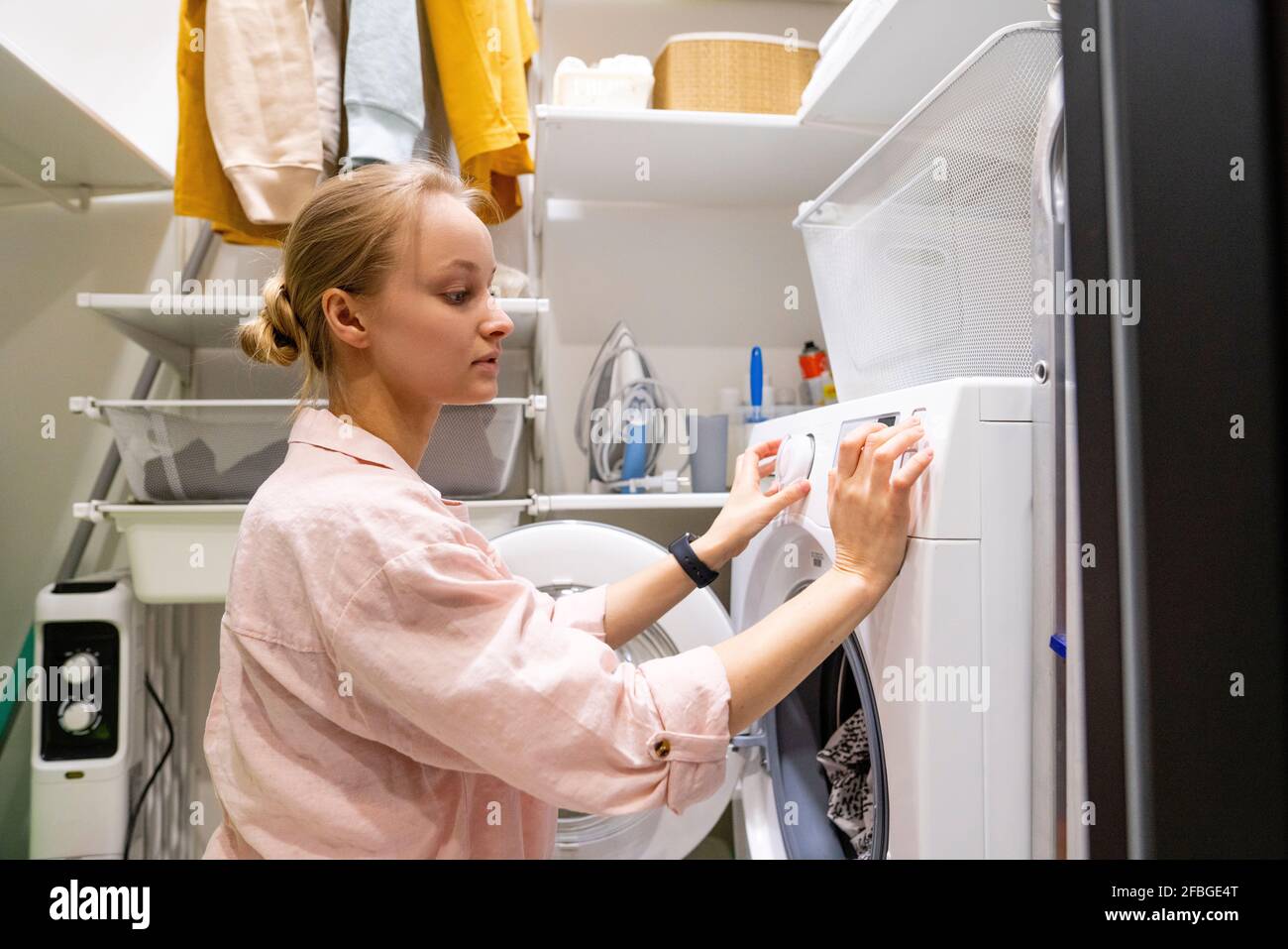 Woman using washing machine hi-res stock photography and images - Alamy