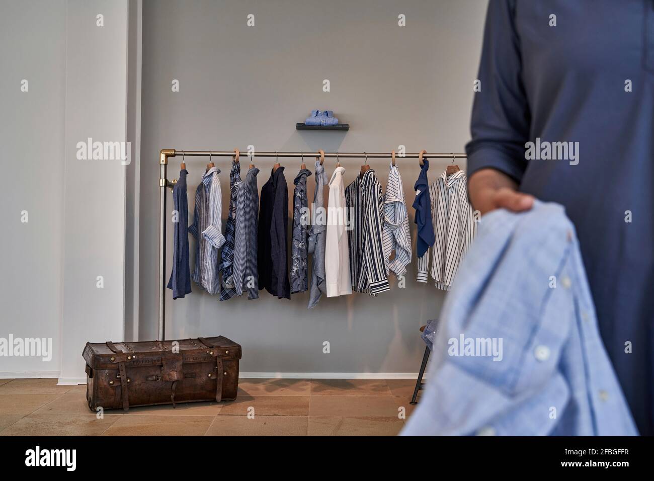 Shirts hanging on rack in clothes design studio Stock Photo - Alamy