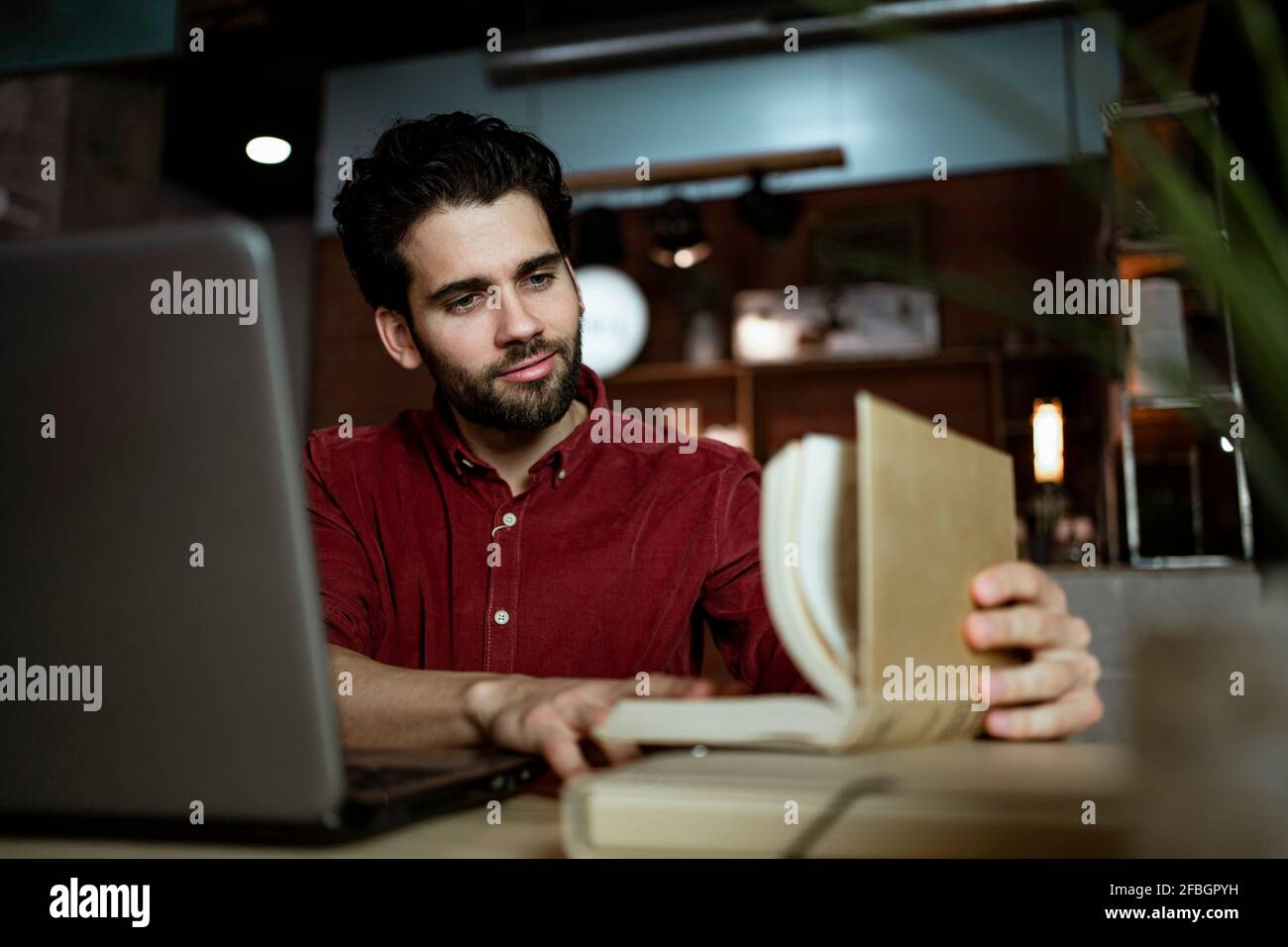 Reading laptop and book hi-res stock photography and images - Alamy