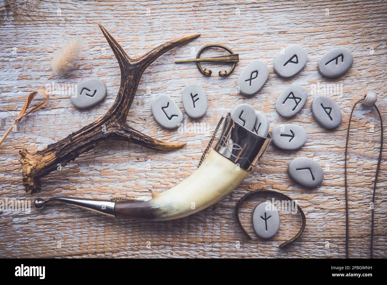 Flat lay view of rune stones with various viking era style objects ...