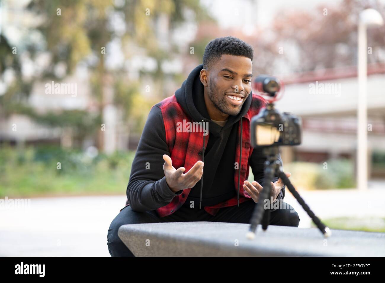 Male influencer vlogging at park Stock Photo - Alamy
