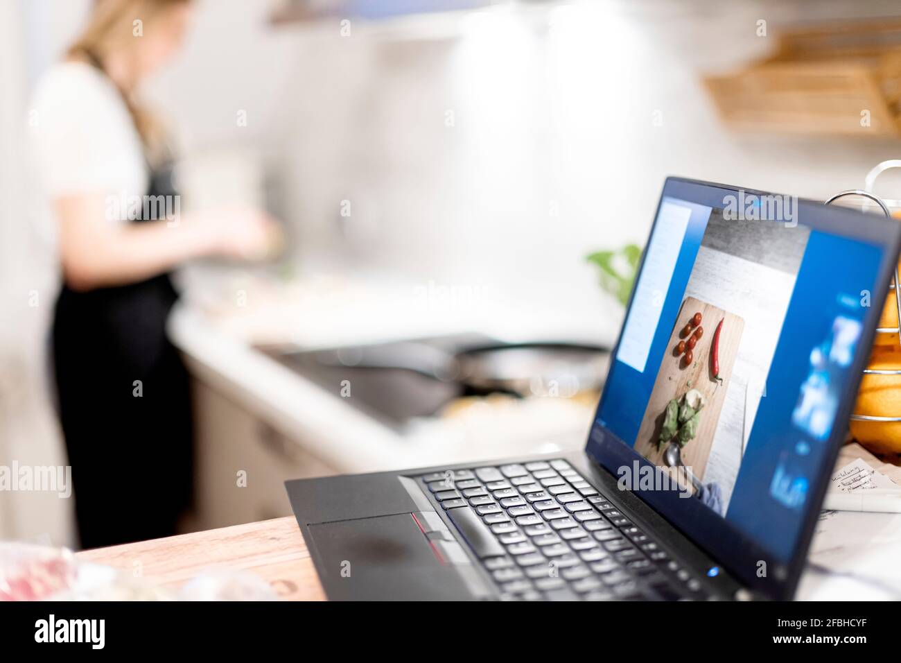 Mature woman laptop kitchen counter hi-res stock photography and images ...