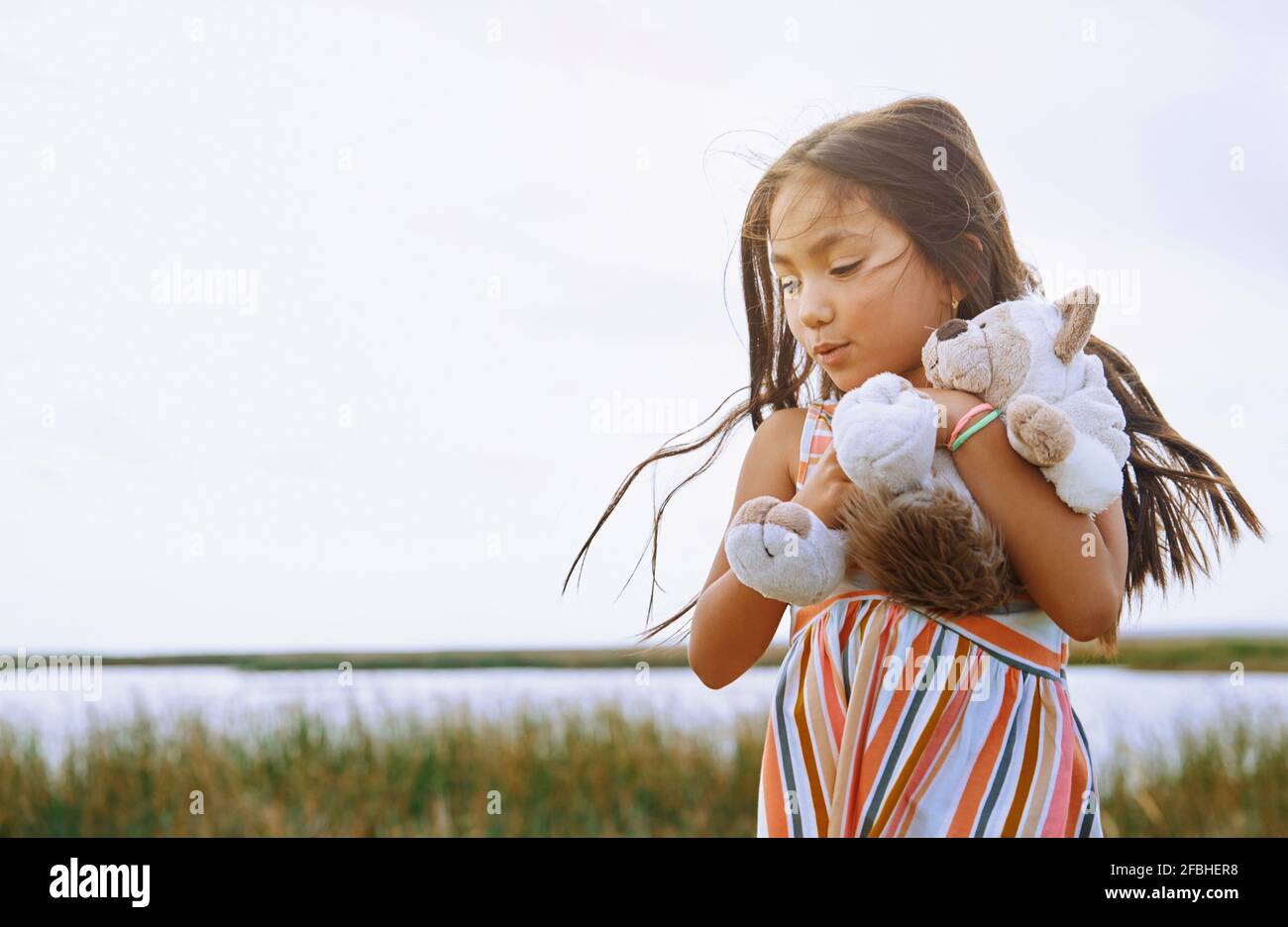 Cute girl holding stuffed toy animal Stock Photo - Alamy