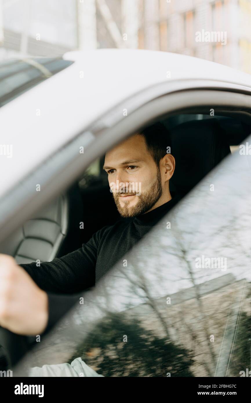 Young man driving electric car hi-res stock photography and images - Alamy