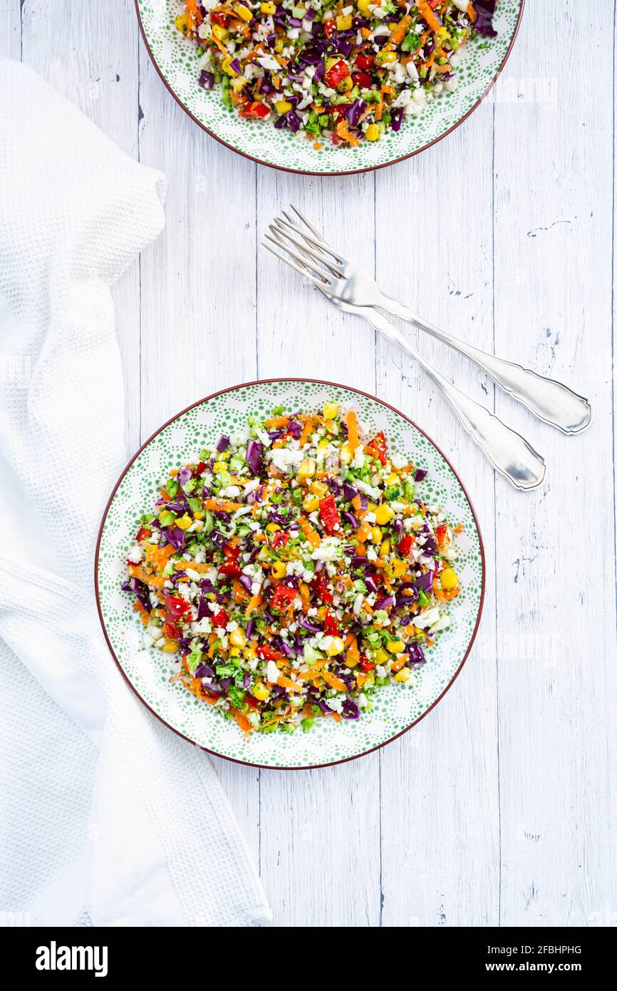 Rainbow salad made out of broccoli, carrot, corn, cauliflower, red ...