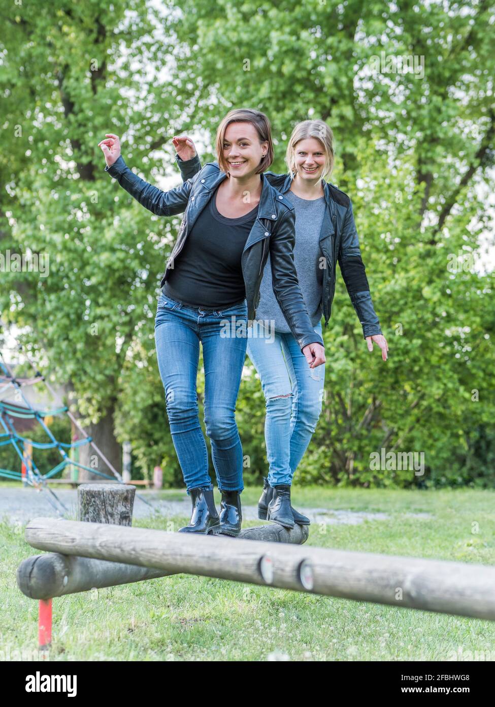 Two friends having fun on playground Stock Photo - Alamy