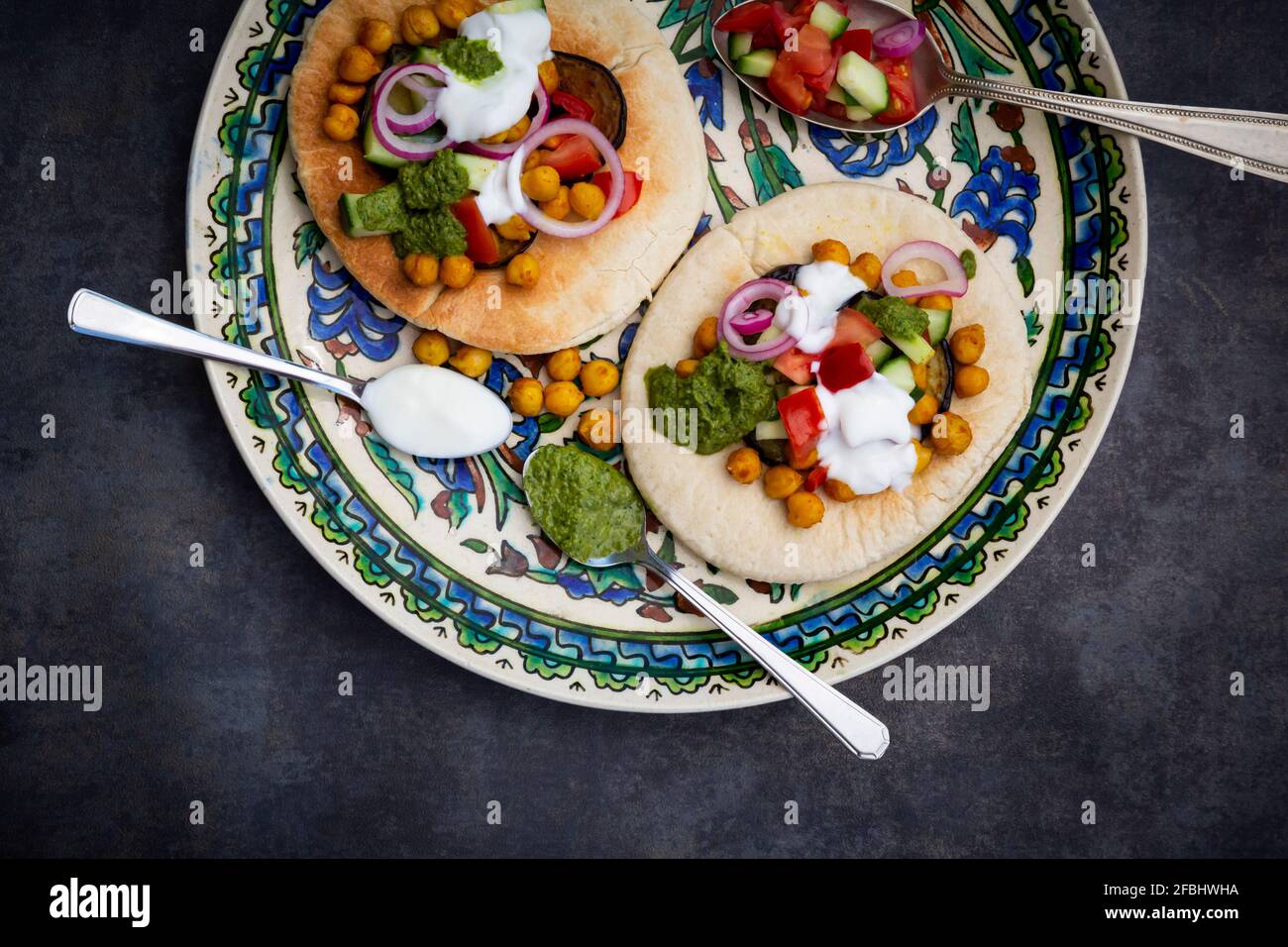 Garnished Sabich, pita bread with fresh vegetables, onions, yogurt and ...