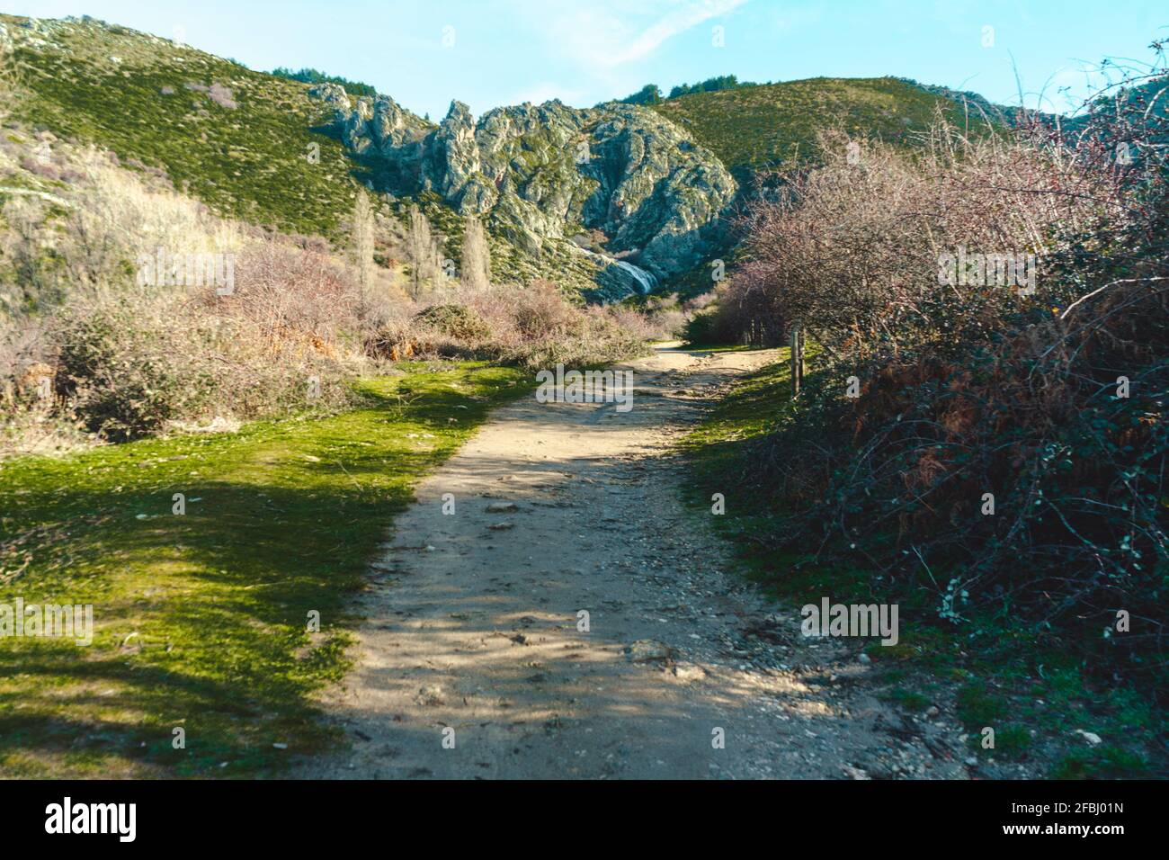 Path in a mountain leading to a waterfall Stock Photo - Alamy