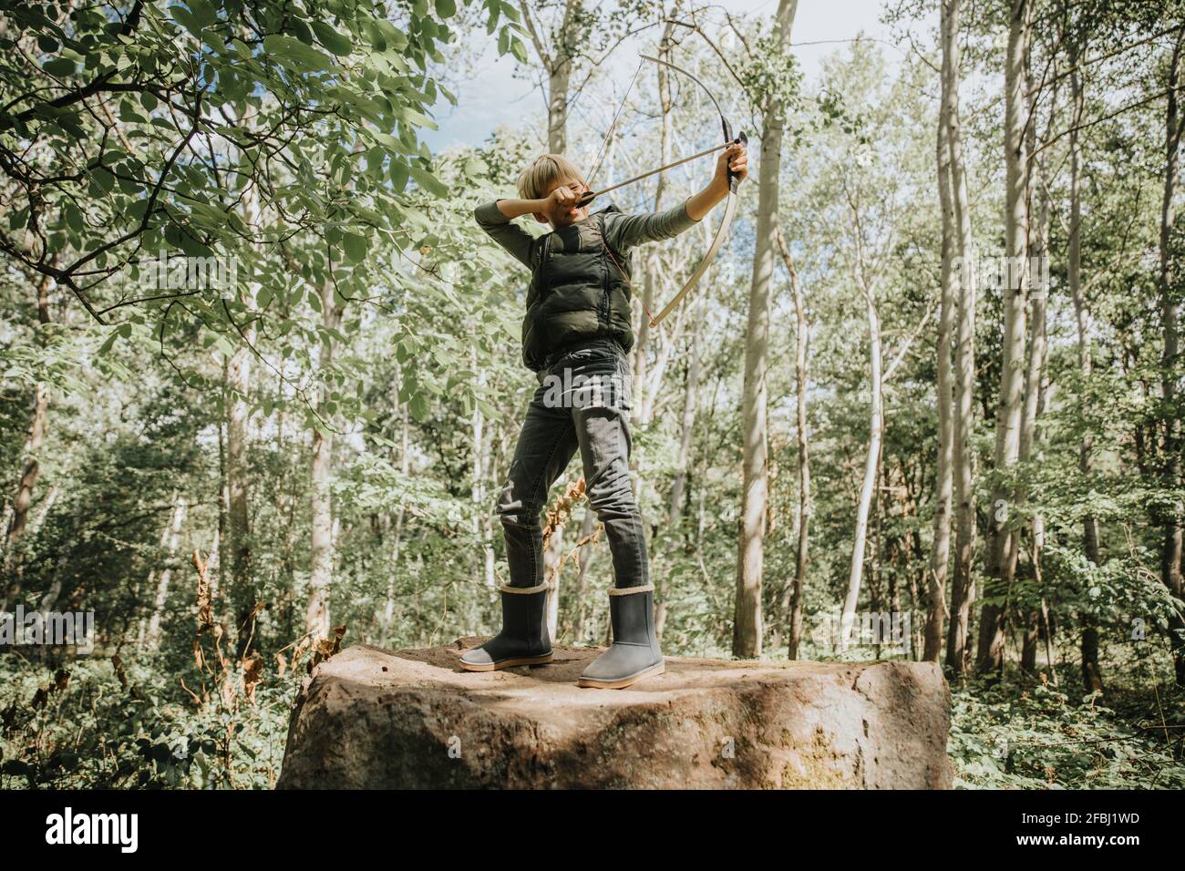 Boy playing with bow and arrow hi-res stock photography and images - Alamy