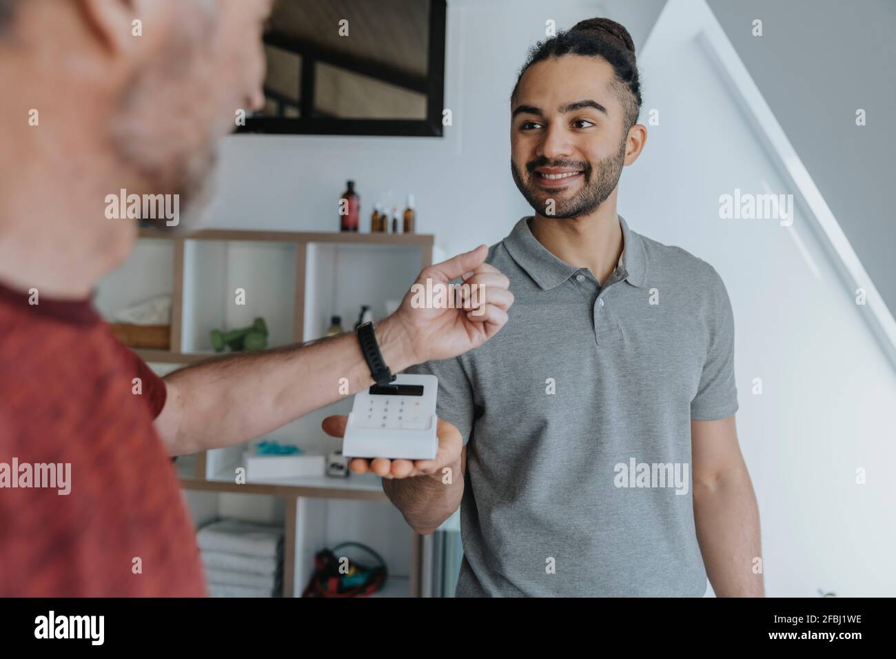 Patient paying through smart watch in medical practice Stock Photo - Alamy