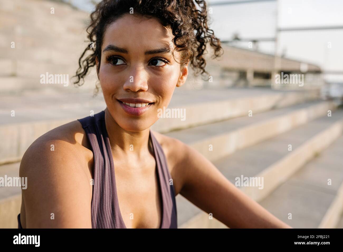 Female sportsperson looking away in sunlight Stock Photo - Alamy