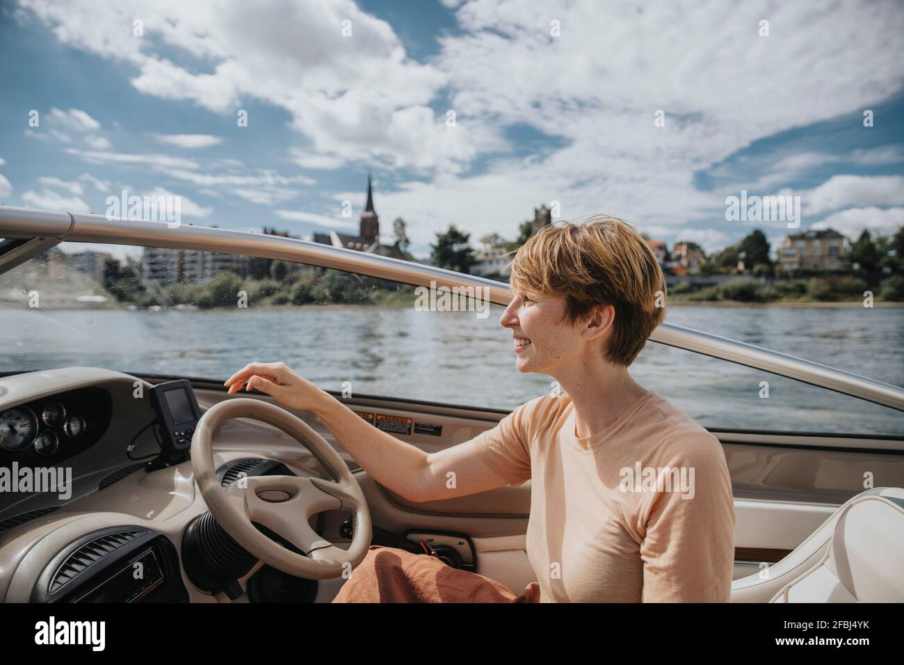 Woman driving boat hi-res stock photography and images - Alamy