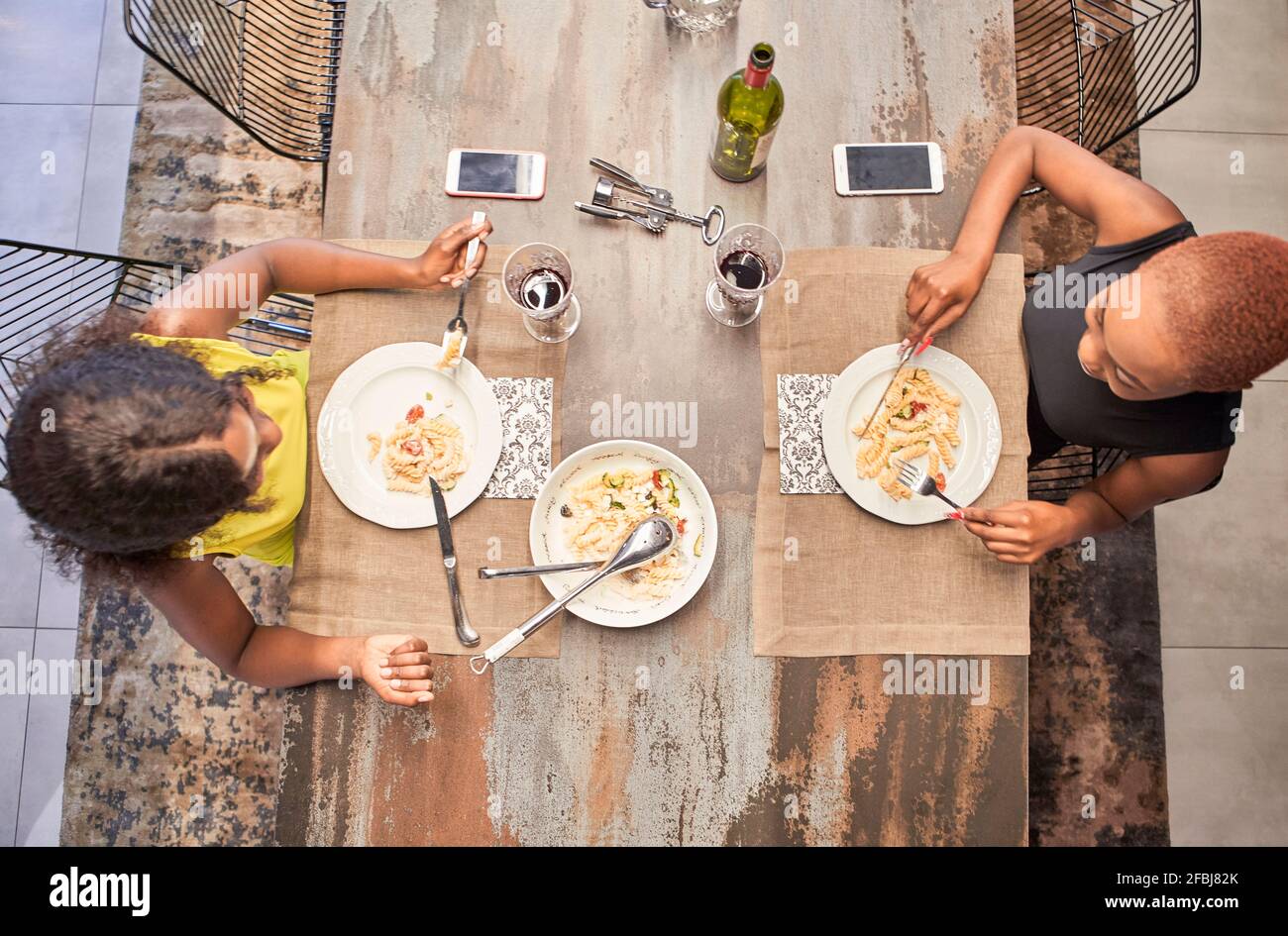Two friends having dinner together, top view Stock Photo - Alamy
