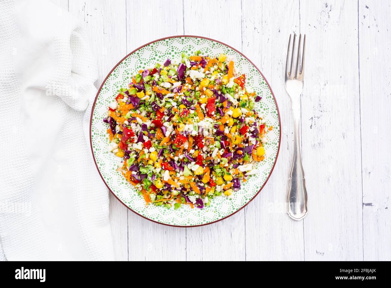 Rainbow salad made out of broccoli, carrot, corn, cauliflower, red ...