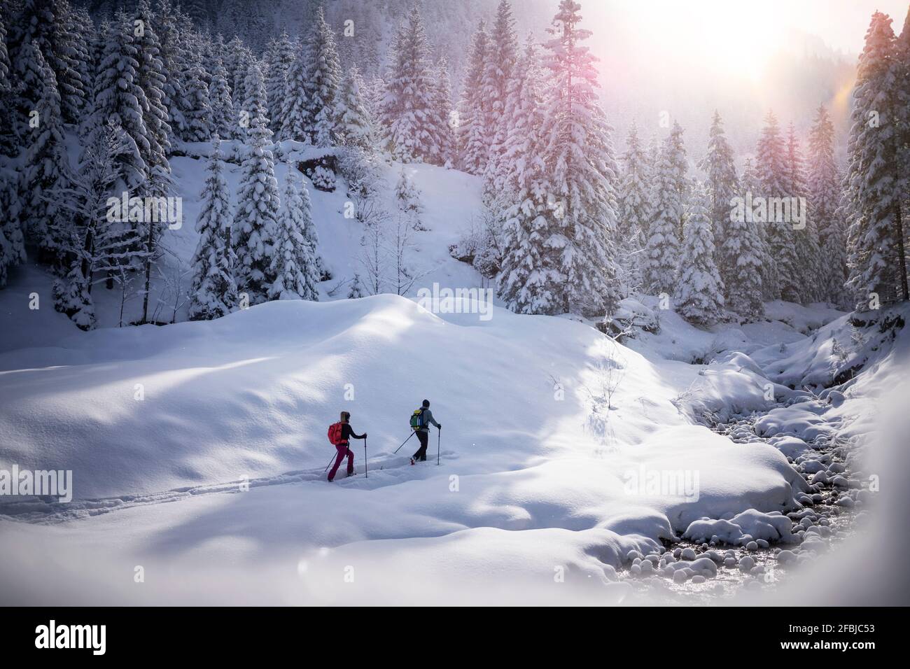 Couple ski touring together during winter Stock Photo - Alamy