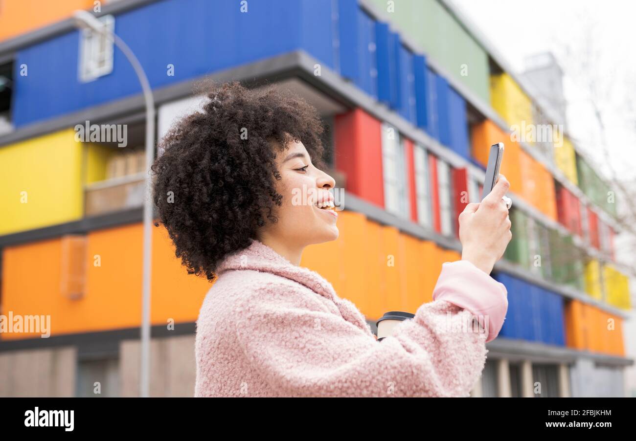 Woman smiling using mobile hi-res stock photography and images - Alamy