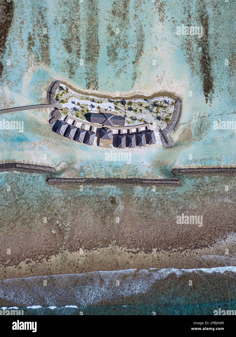 Maldives, Kaafu atoll, Aerial view of tourist resort on tropical sandy ...