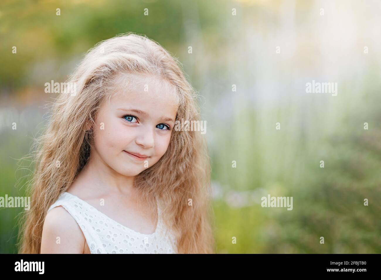 Close up portrait of pretty, blue eyed, fair skinned girl with happy ...