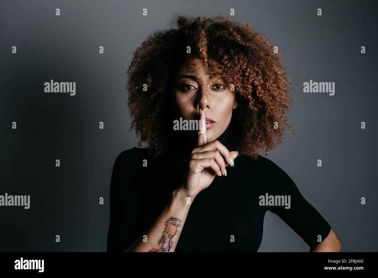 Finger over lips hi-res stock photography and images - Alamy