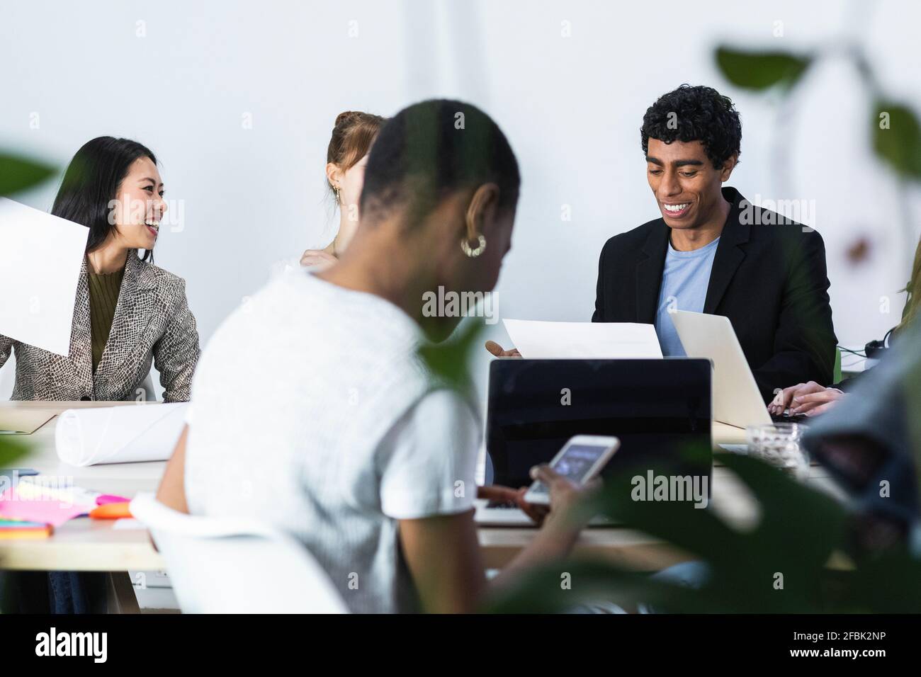 Smiling business people in meeting at workplace Stock Photo - Alamy