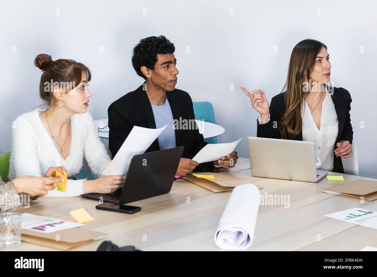 Business people having discussion while sitting in meeting Stock Photo ...
