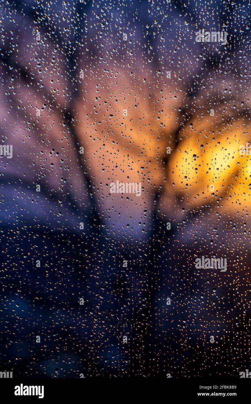 Raindrops on window pane at sunset Stock Photo - Alamy