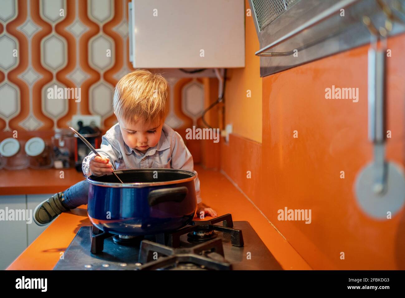 Boy sitting on counter hi-res stock photography and images - Alamy