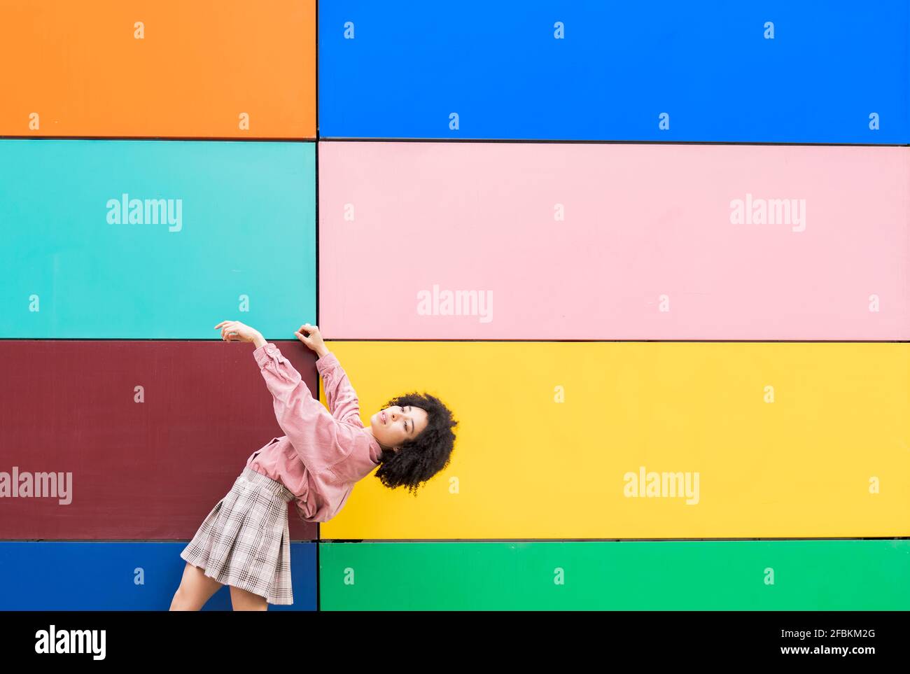 Female dancer bending over backwards while standing by multi colored ...