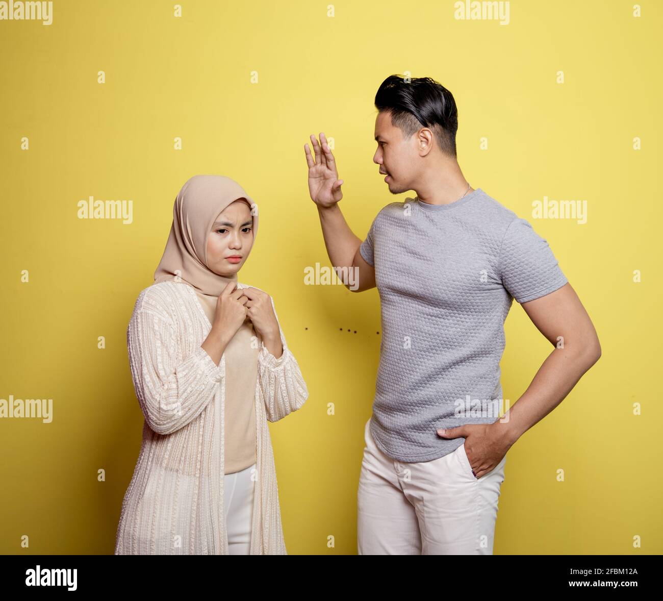 two young couples in a problem. a man warning women don't do it again Stock Photo - Alamy