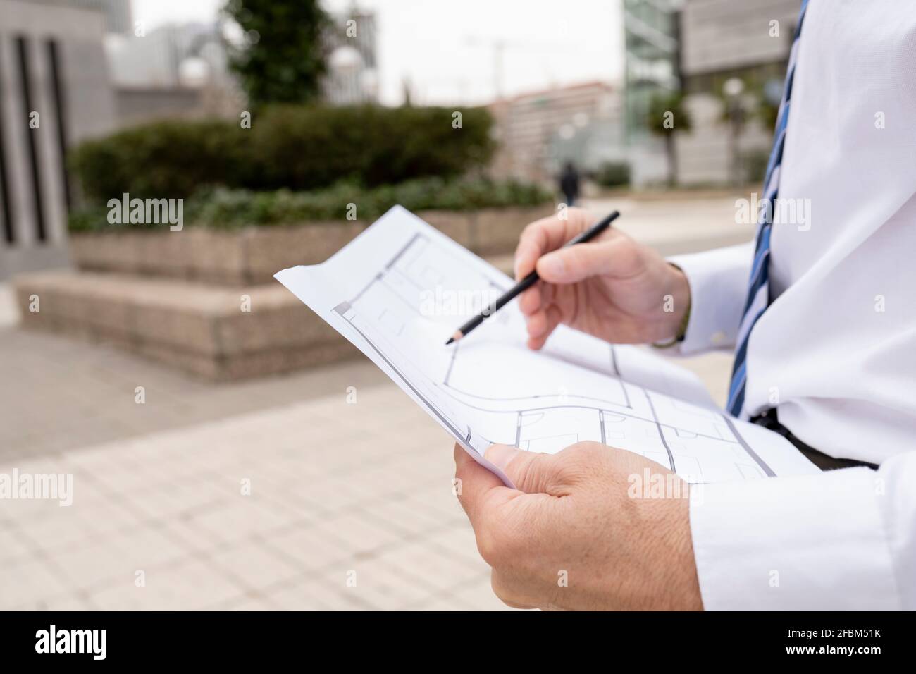 Male design professional working on blueprint Stock Photo - Alamy