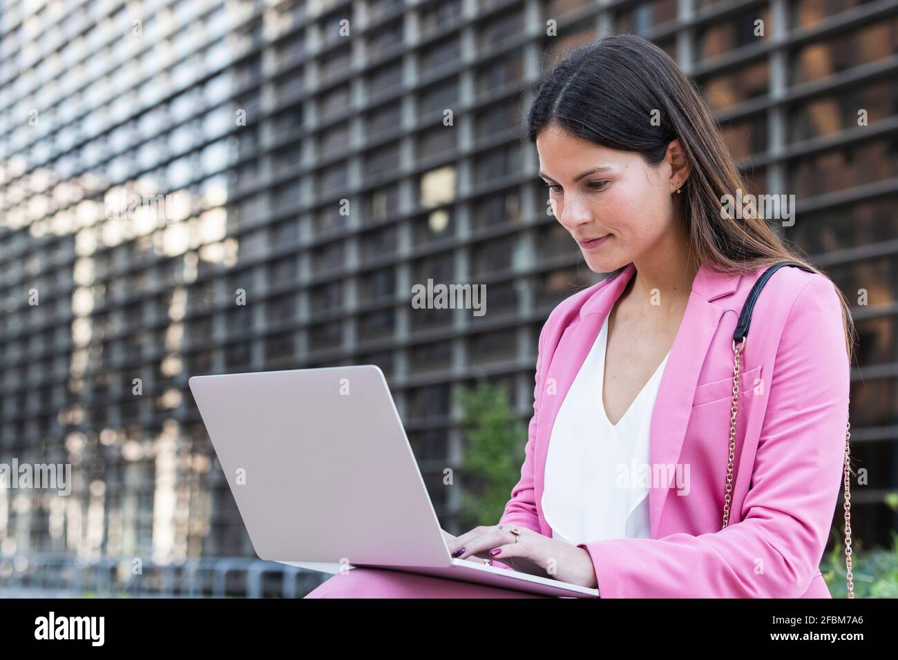 Young female entrepreneur working on laptop Stock Photo - Alamy