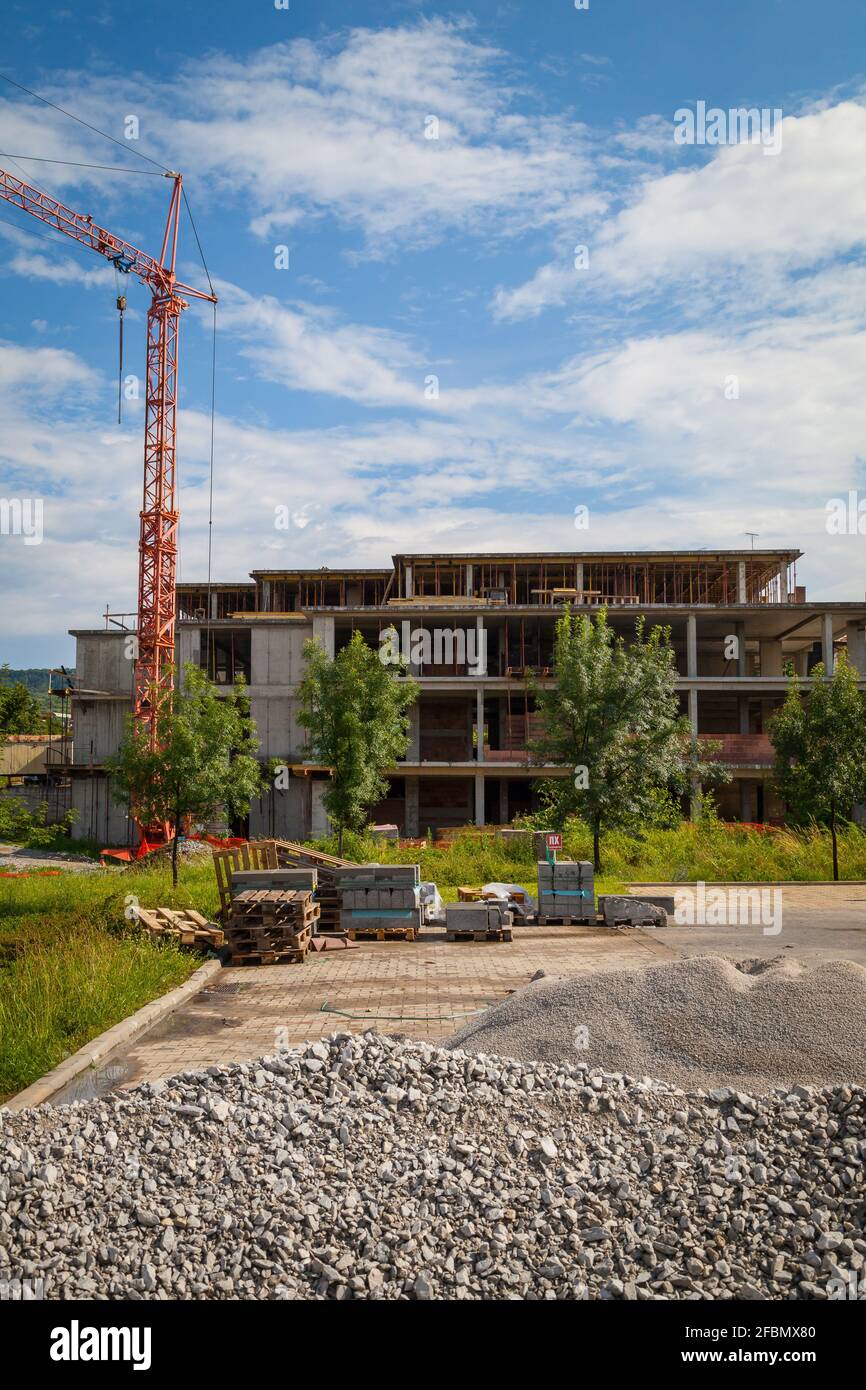 Construction site with crane and unfinished building Stock Photo - Alamy