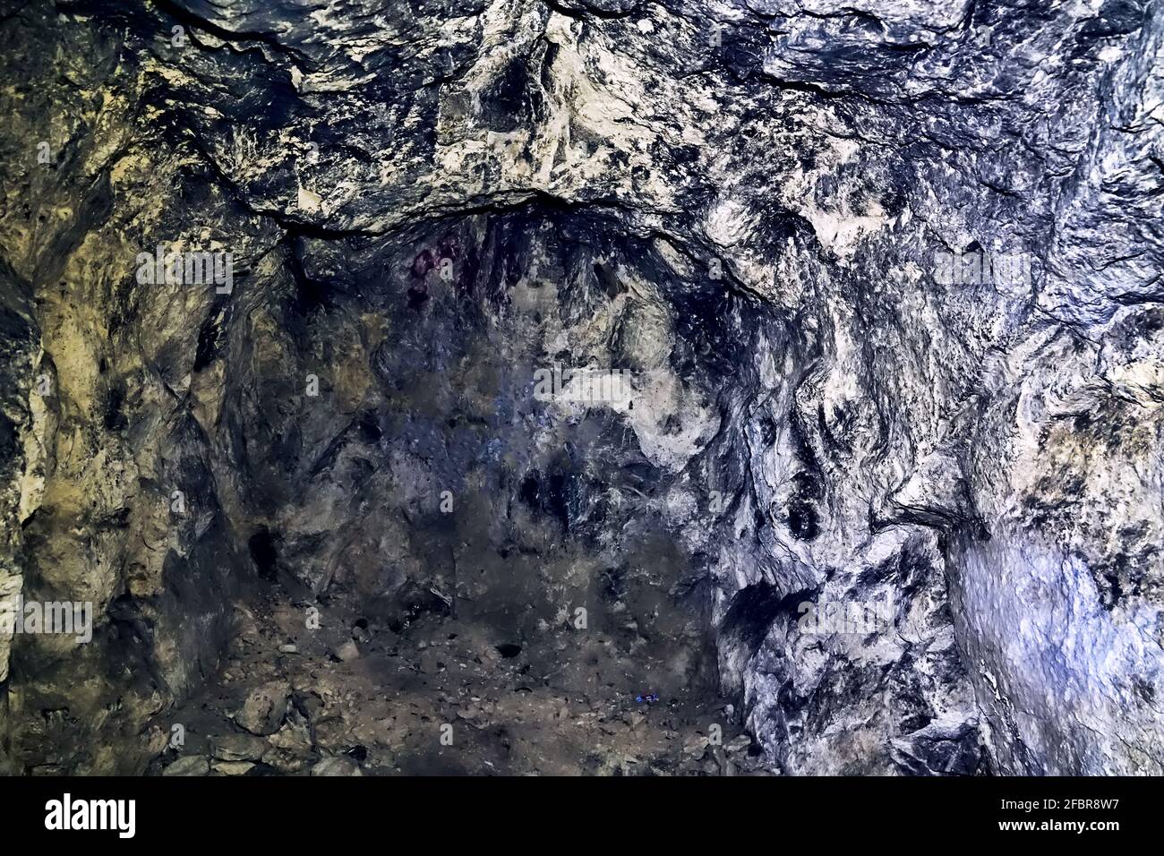 An old flooded mine, an underground corridor, and walls covered with ...