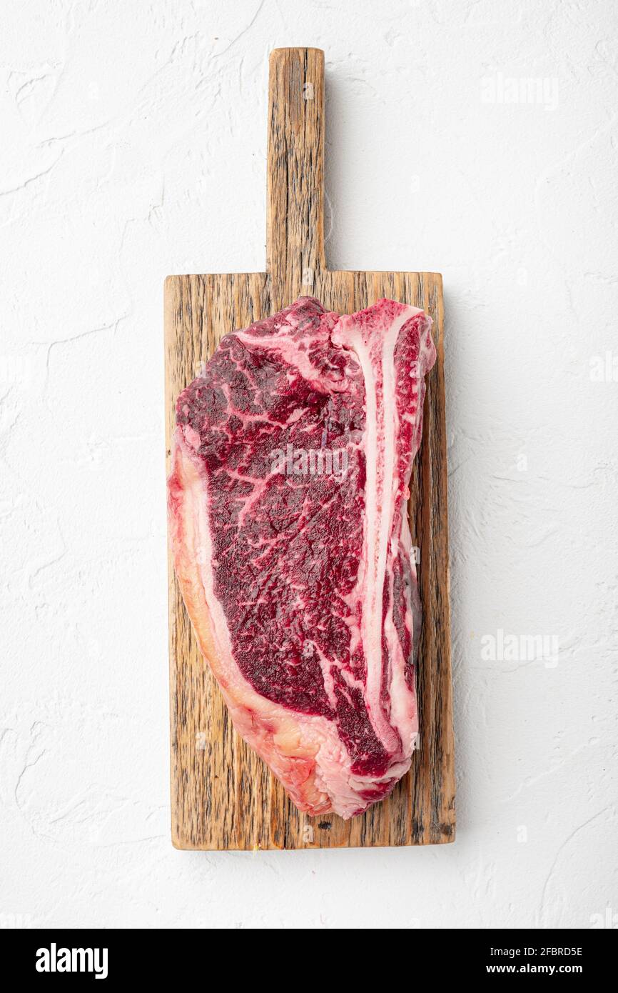 Dry aged club steak set, on white stone background, top view flat lay ...
