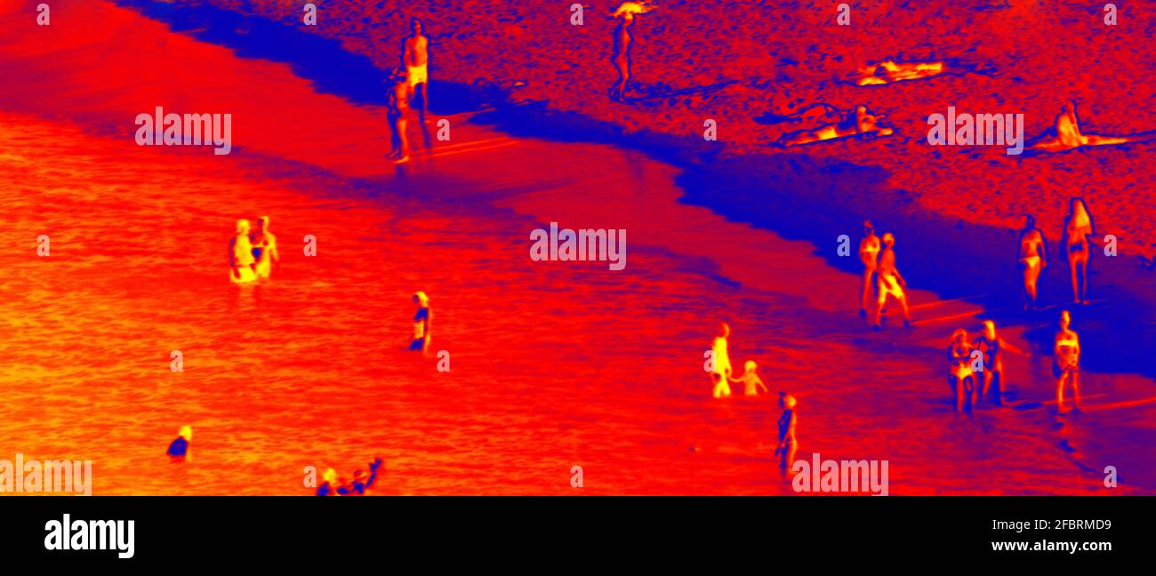 Beach, sea and beach-goers. Scanning the people's body temperature with ...